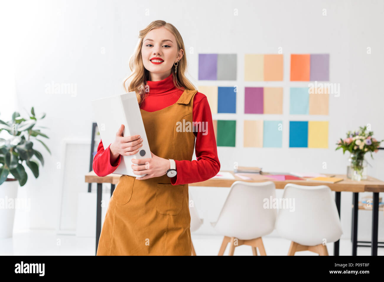 beautiful magazine editor with folder in office with color palette on ...