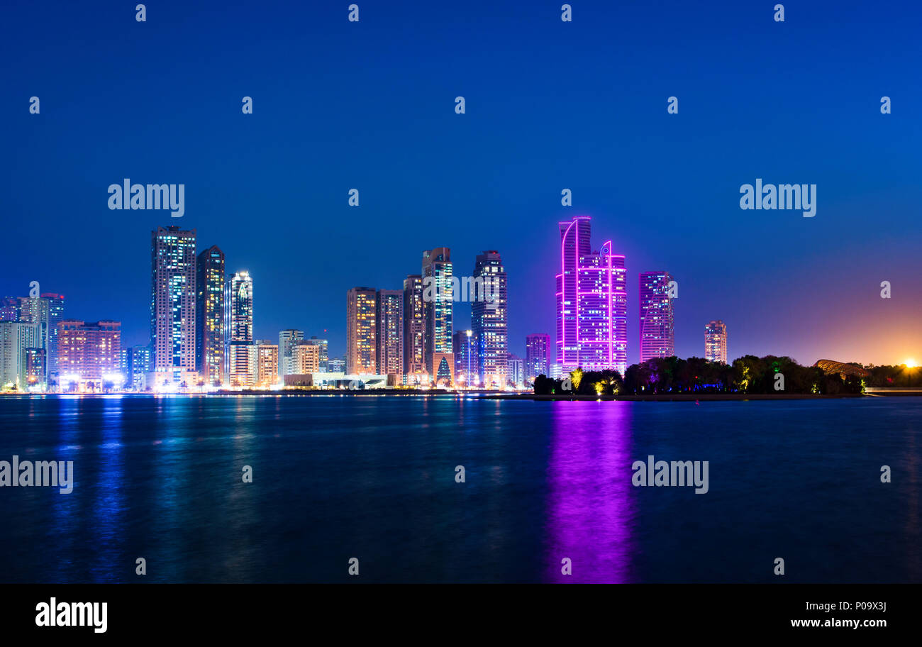 Sharjah modern waterfront cityscape in UAE at blue hour Stock Photo - Alamy
