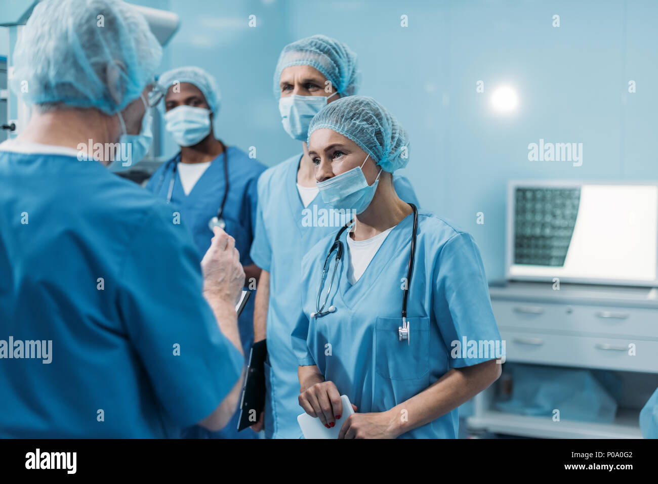 four multicultural surgeons talking in operating room Stock Photo - Alamy