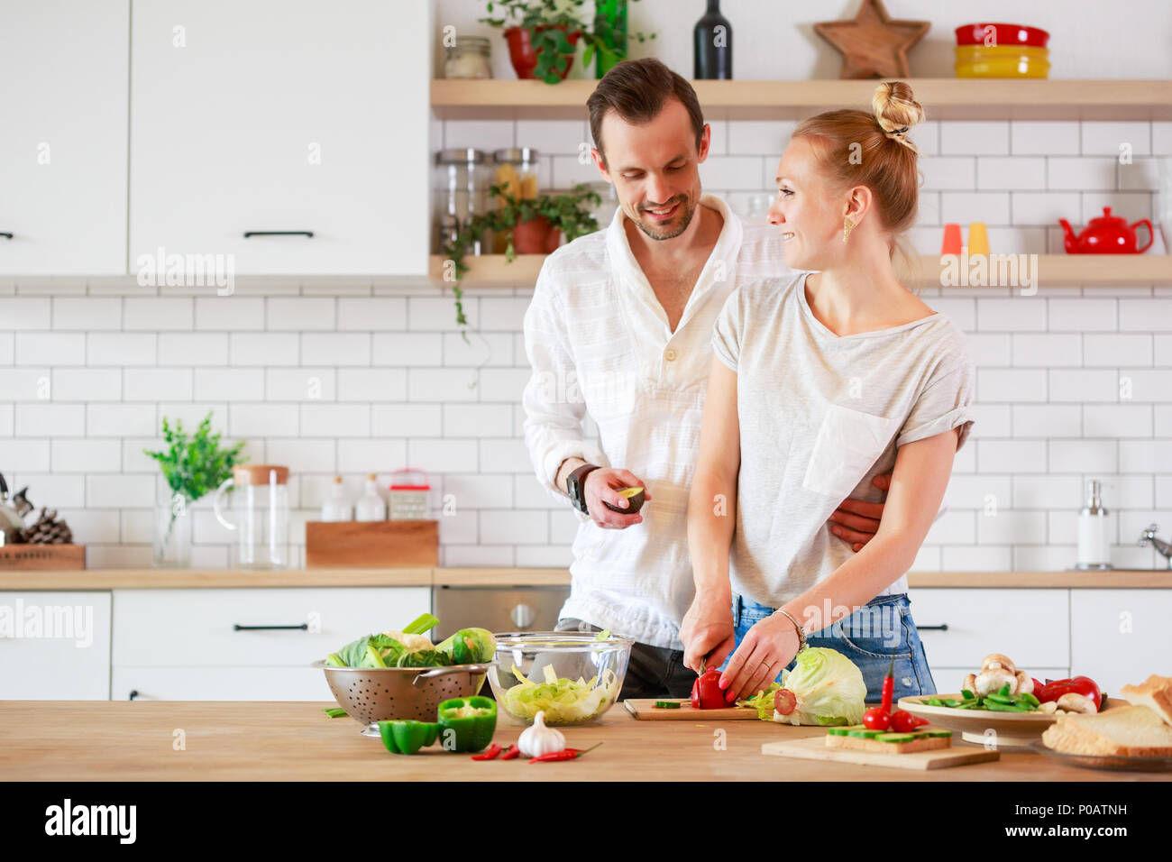 Photo of beautiful loving couple cooking vegetables in kitchen Stock ...