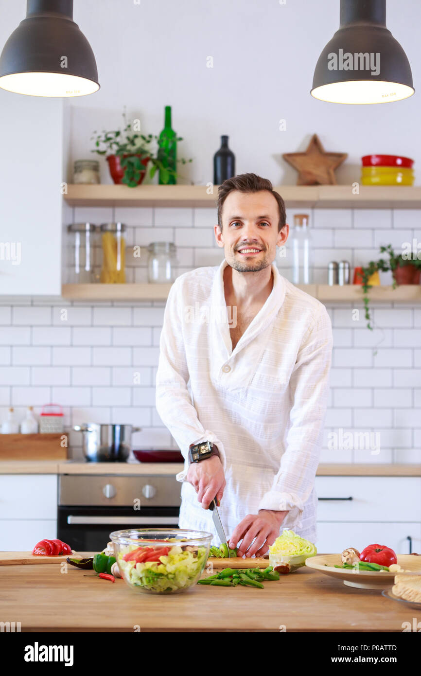Photo of young man cooking food Stock Photo - Alamy
