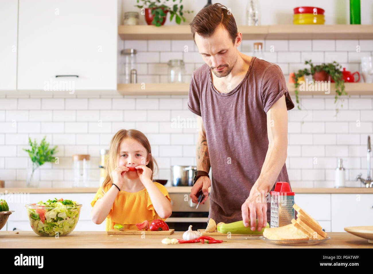Picture of man with his daughter cooking dinner Stock Photo - Alamy