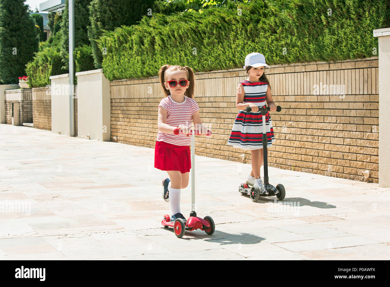 Child riding step scooter hi-res stock photography and images - Alamy