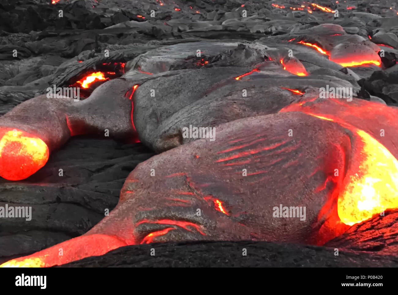 Pouring lava on the slope of the volcano. Volcanic eruption and magma ...