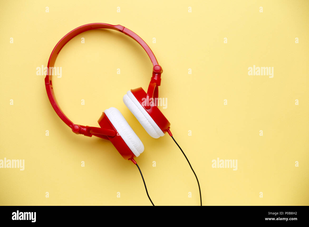 Image of red with white headphones for music Stock Photo - Alamy