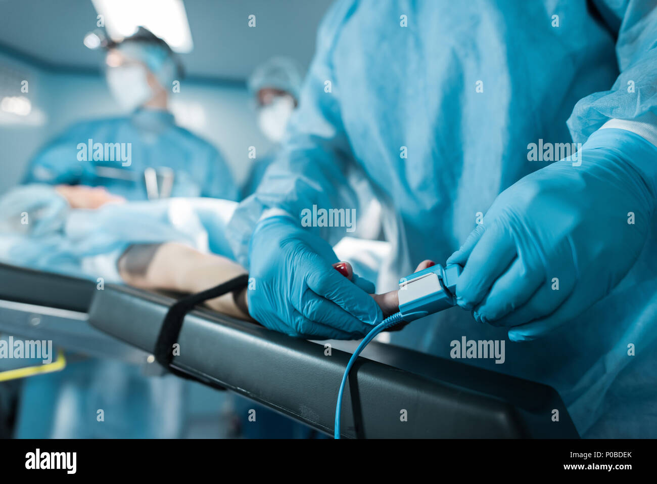 cropped image of doctor wearing pulse oximeter on patient finger in ...