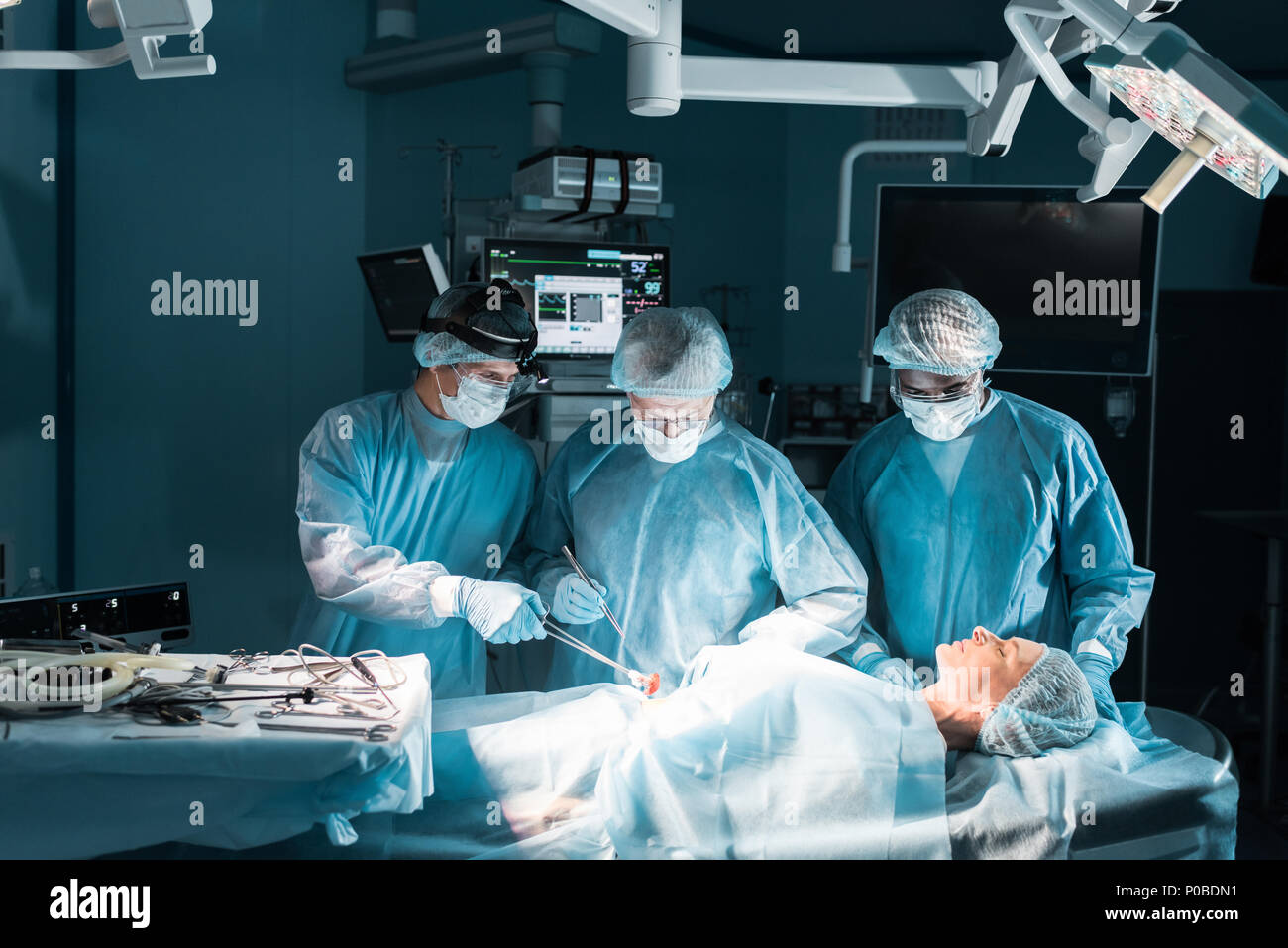 multicultural surgeons and patient during surgery Stock Photo - Alamy