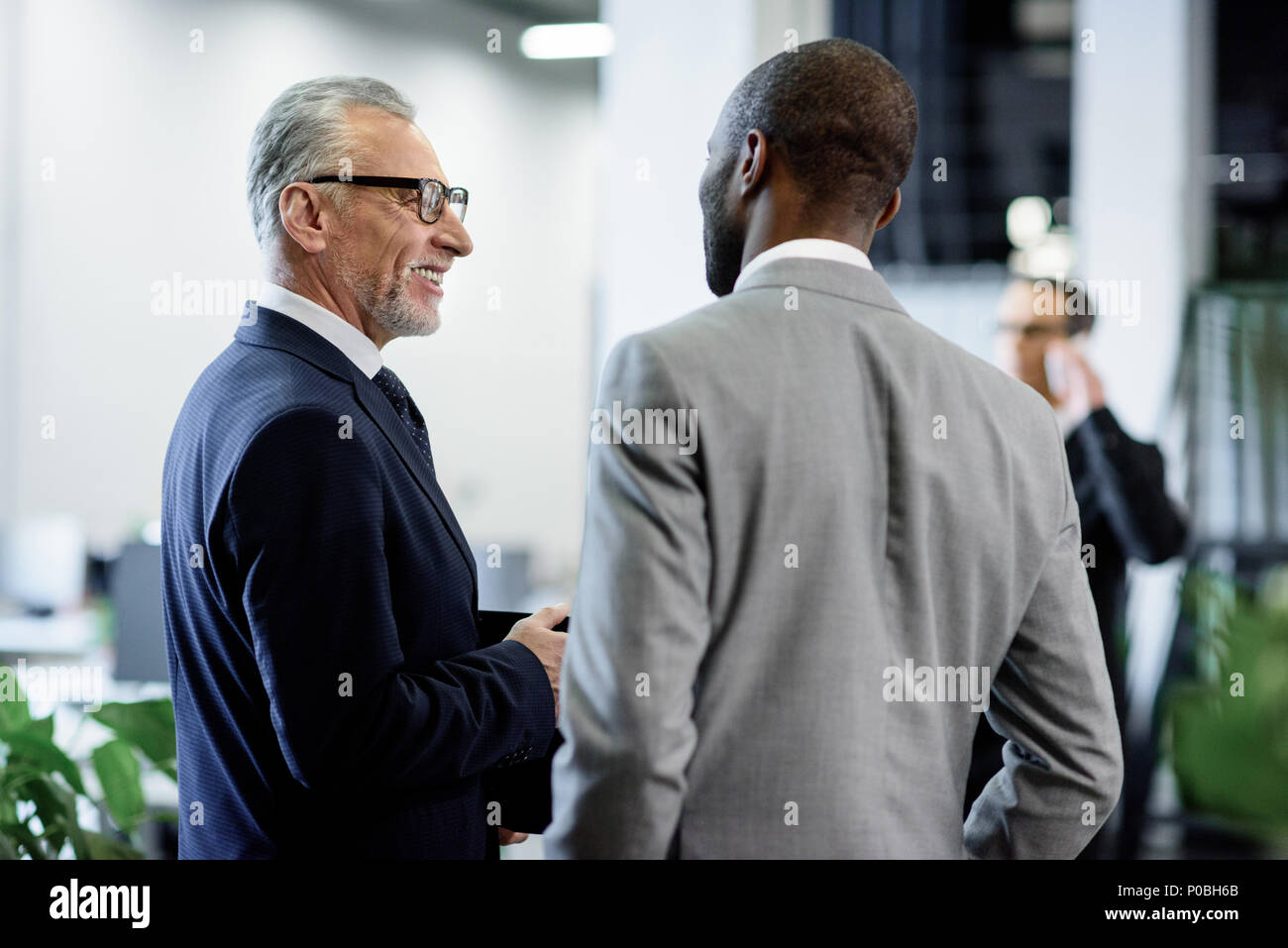 selective focus of multicultural businessmen having conversation in ...