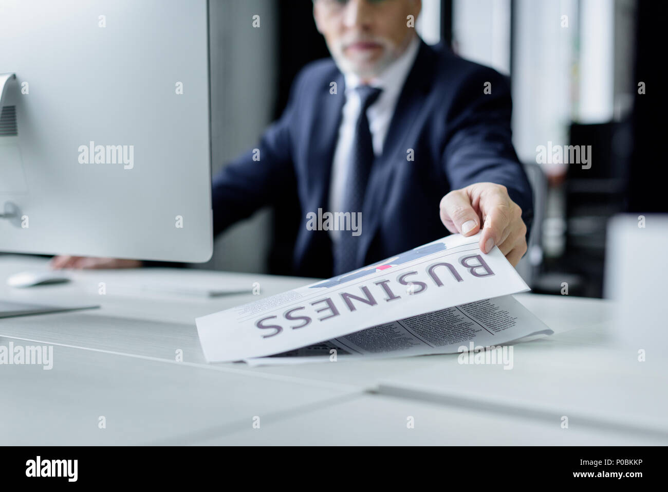 senior businessman taking newspaper at workplace in office Stock Photo ...