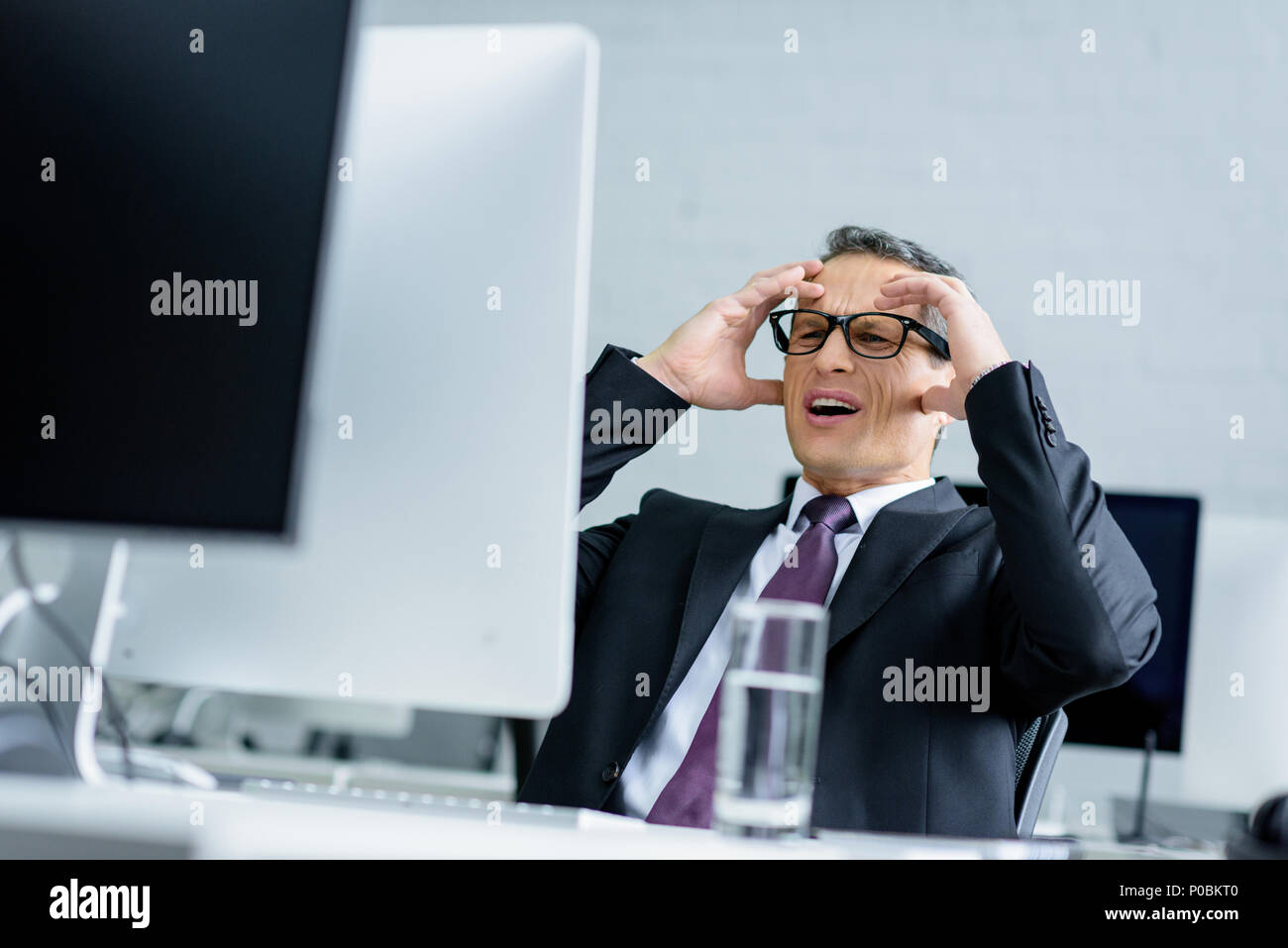 stressed businessman looking at computer screen at workplace Stock ...