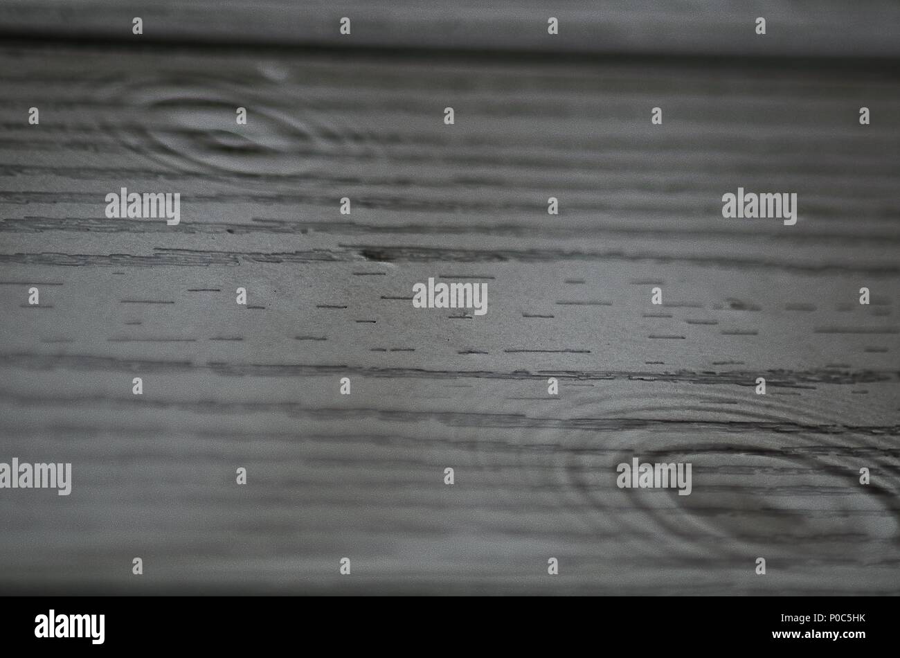 Two droplets on a puddle over wood plank Stock Photo - Alamy