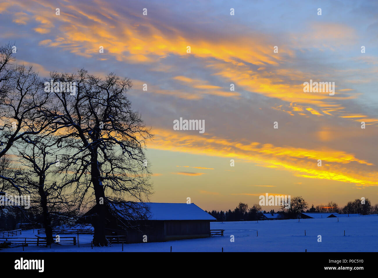 Sunset in winter over snowfield with barn Stock Photo - Alamy