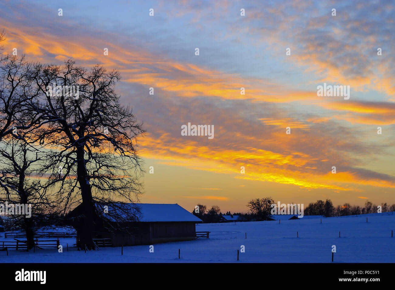 Sunset in winter over snowfield with barn Stock Photo - Alamy
