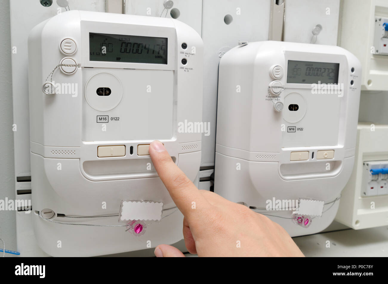 Electric energy meter. Electrical technician servicing unit Stock Photo ...