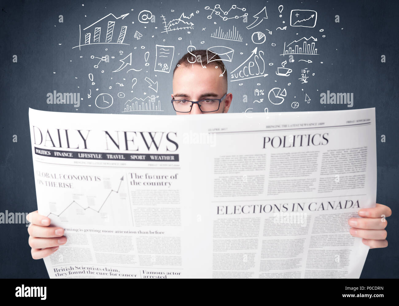 Young smart businessman reading daily newspaper with business plan ...