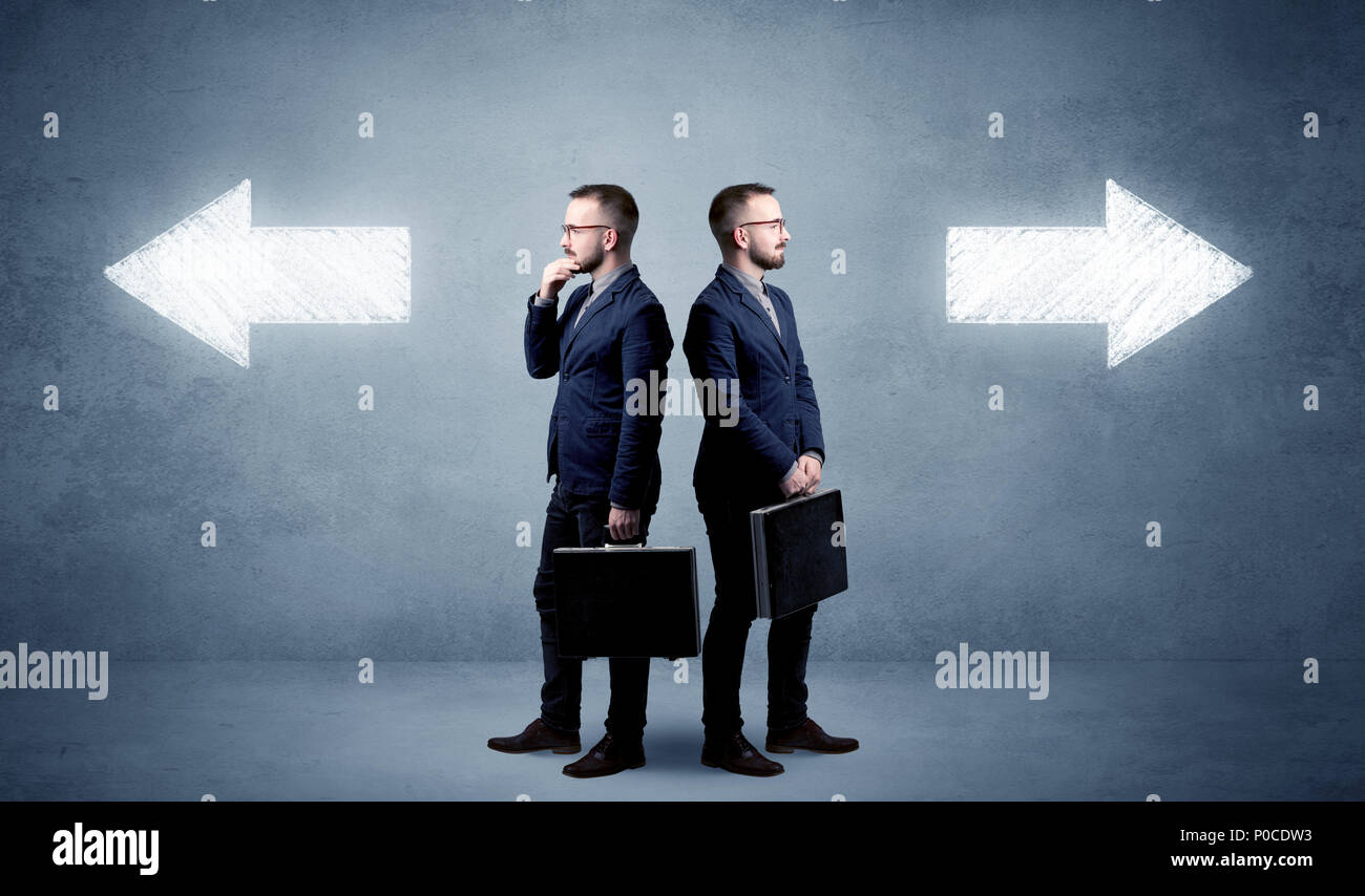 Young conflicted businessman choosing between two directions Stock ...