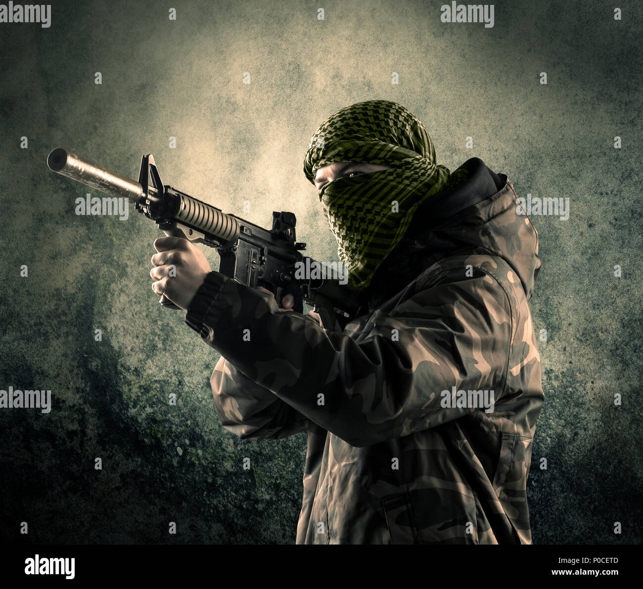 Portrait of a heavily armed masked soldier with grungy background ...