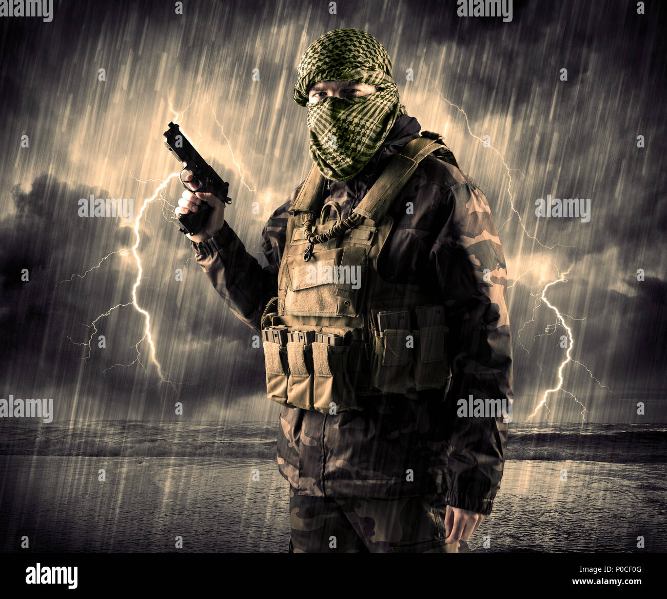 Portrait of a dangerous armed terrorist with mask and gun in a ...