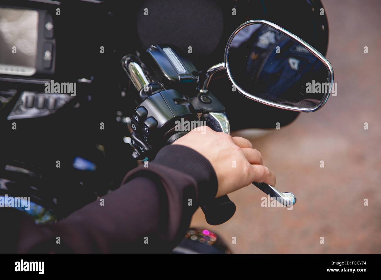 Close up Hand a man hold manual brake and stop running of motor cycle ...