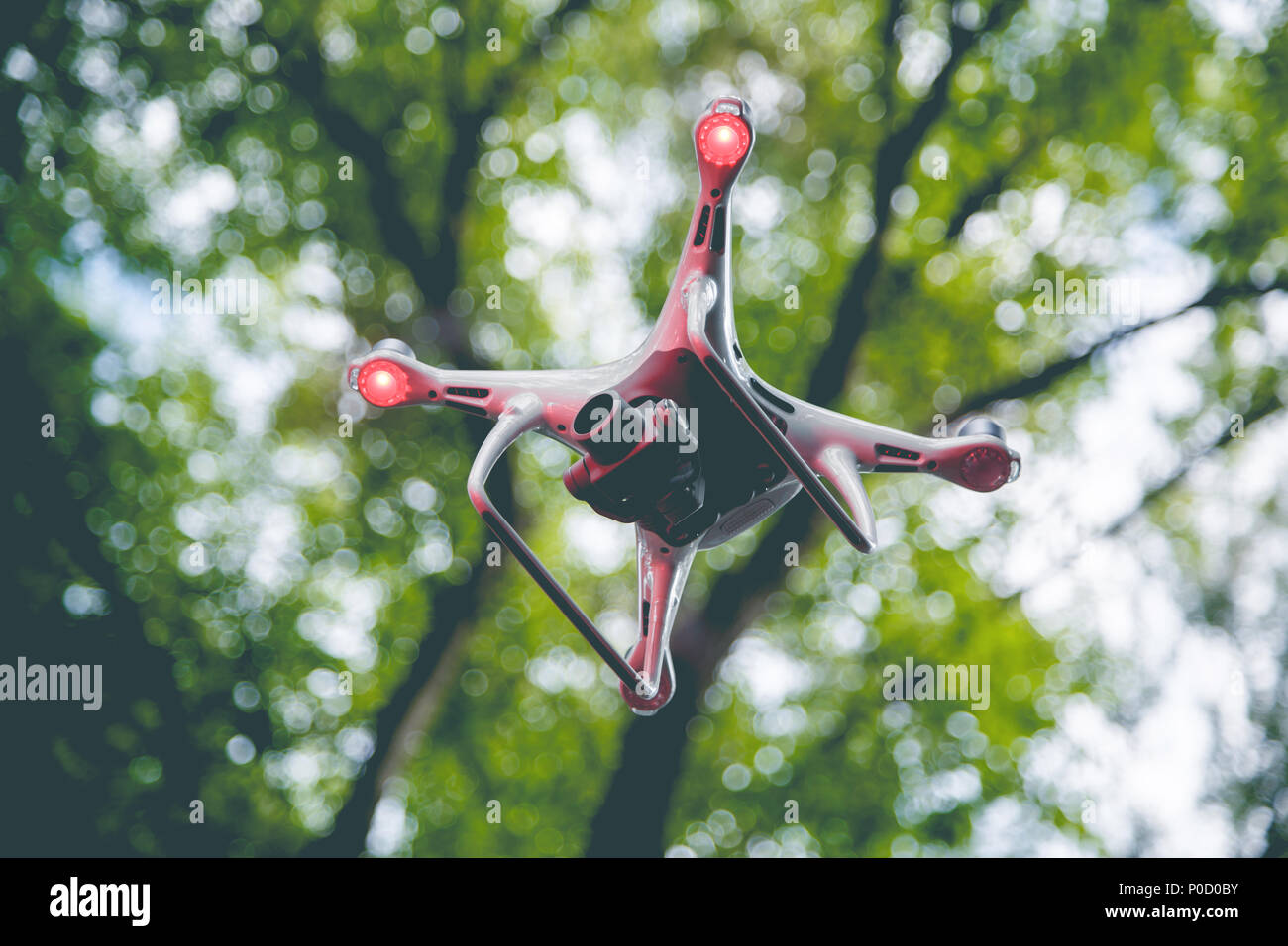 Drone with camera flying on green nature background Stock Photo - Alamy