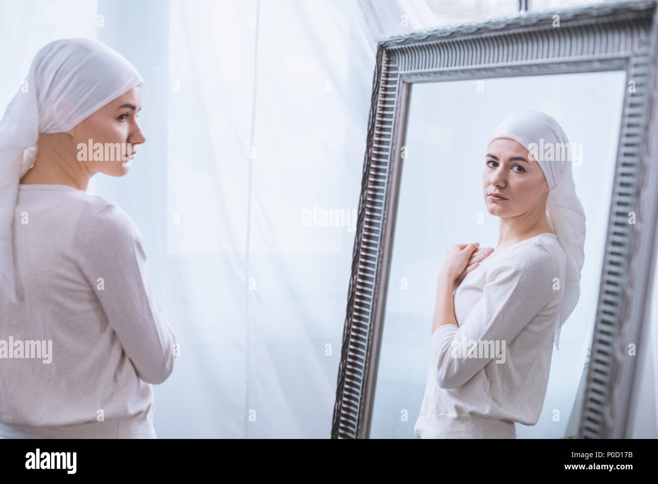 young sick woman in kerchief looking at mirror, cancer concept Stock ...