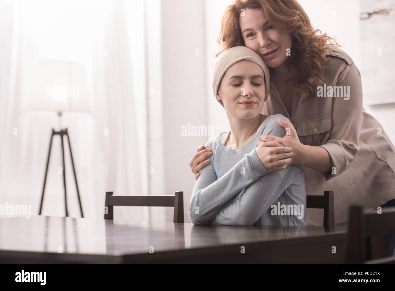 Woman hugging sick daughter hi-res stock photography and images - Alamy
