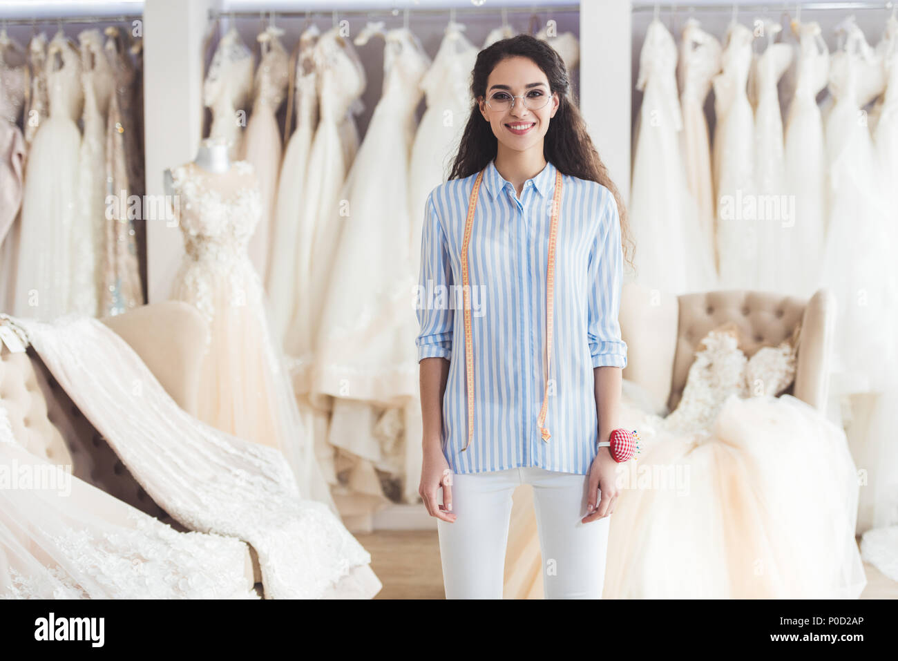 Young female tailor standing in wedding atelier Stock Photo - Alamy
