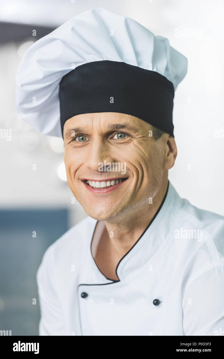 portrait of smiling handsome chef at restaurant kitchen Stock Photo - Alamy
