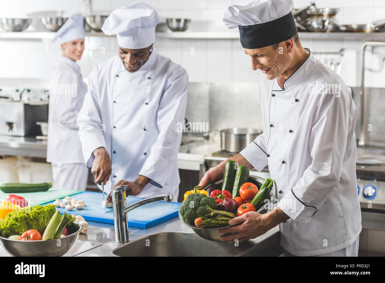 multicultural chefs preparing at restaurant kitchen Stock Photo - Alamy