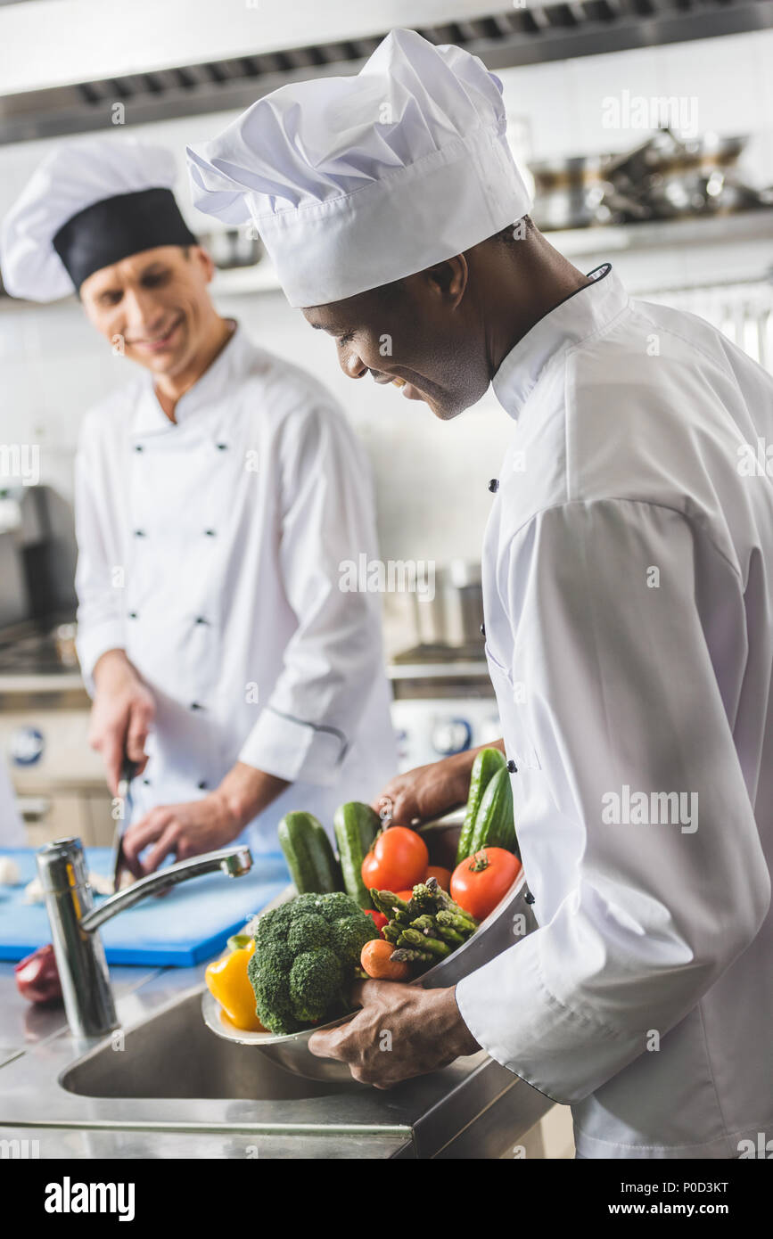 african american chef washing vegetables at restaurant kitchen Stock ...