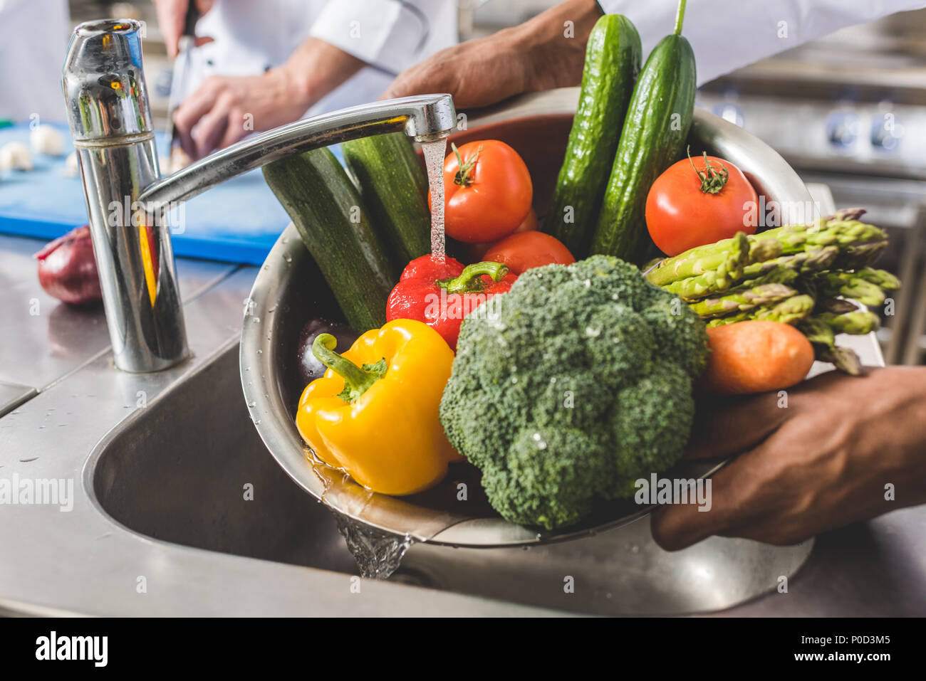 Male chef washing vegetables hi-res stock photography and images - Alamy