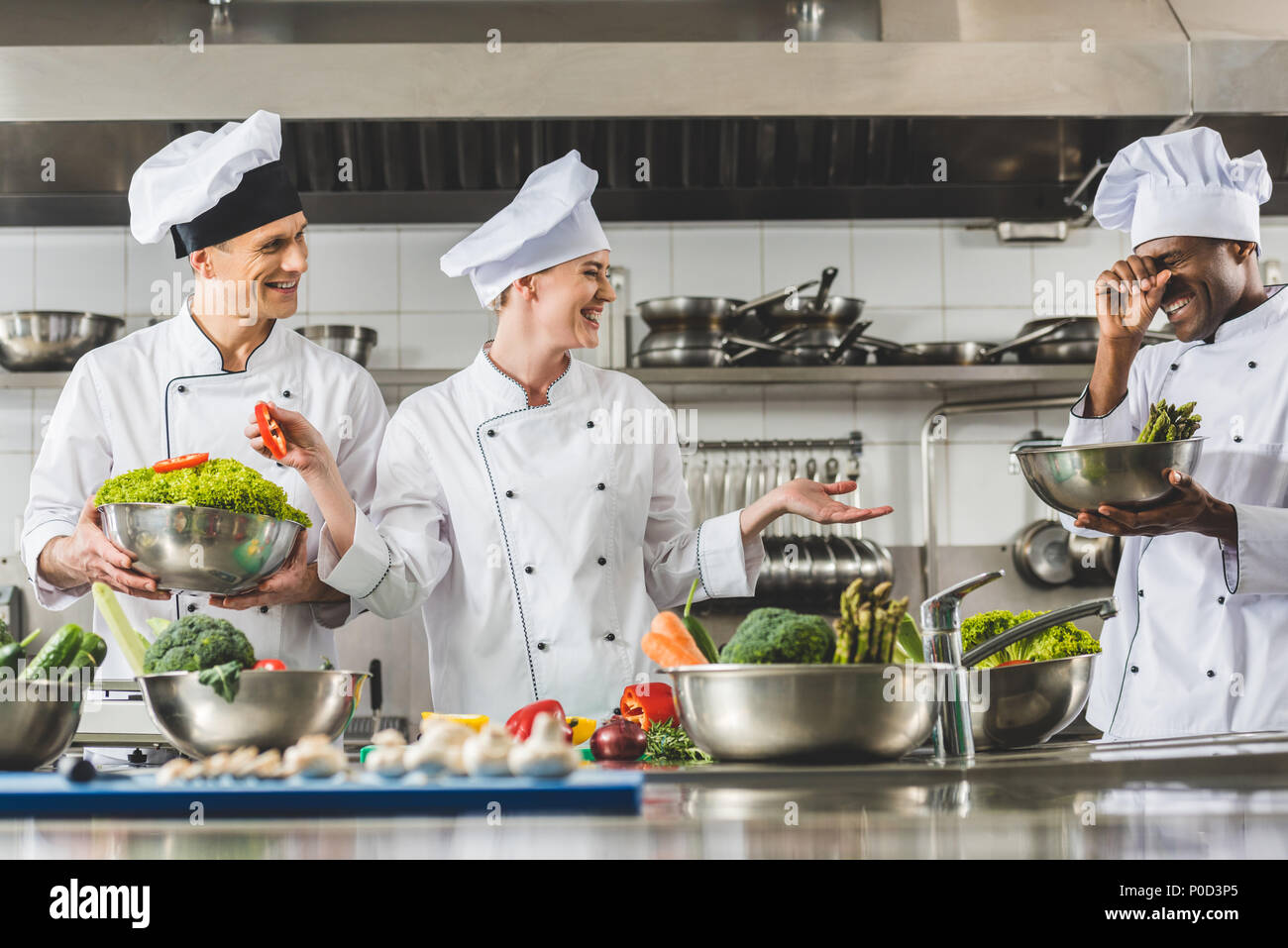 multicultural chefs laughing at restaurant kitchen Stock Photo - Alamy