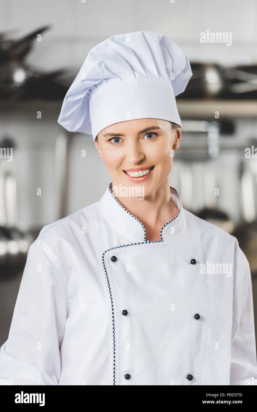 portrait of smiling attractive chef at restaurant kitchen Stock Photo ...