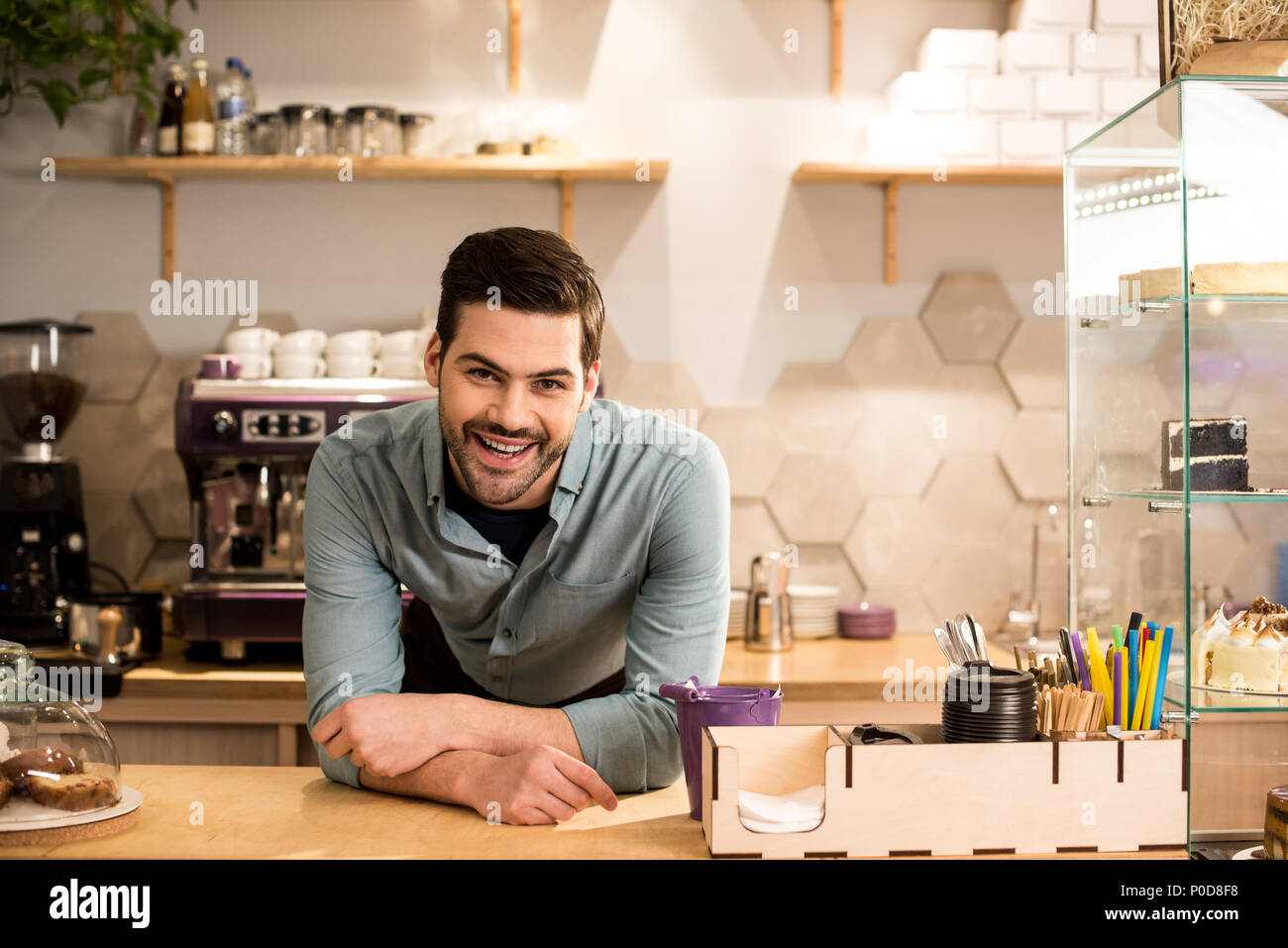 Handsome man leaning on counter hi-res stock photography and images - Alamy