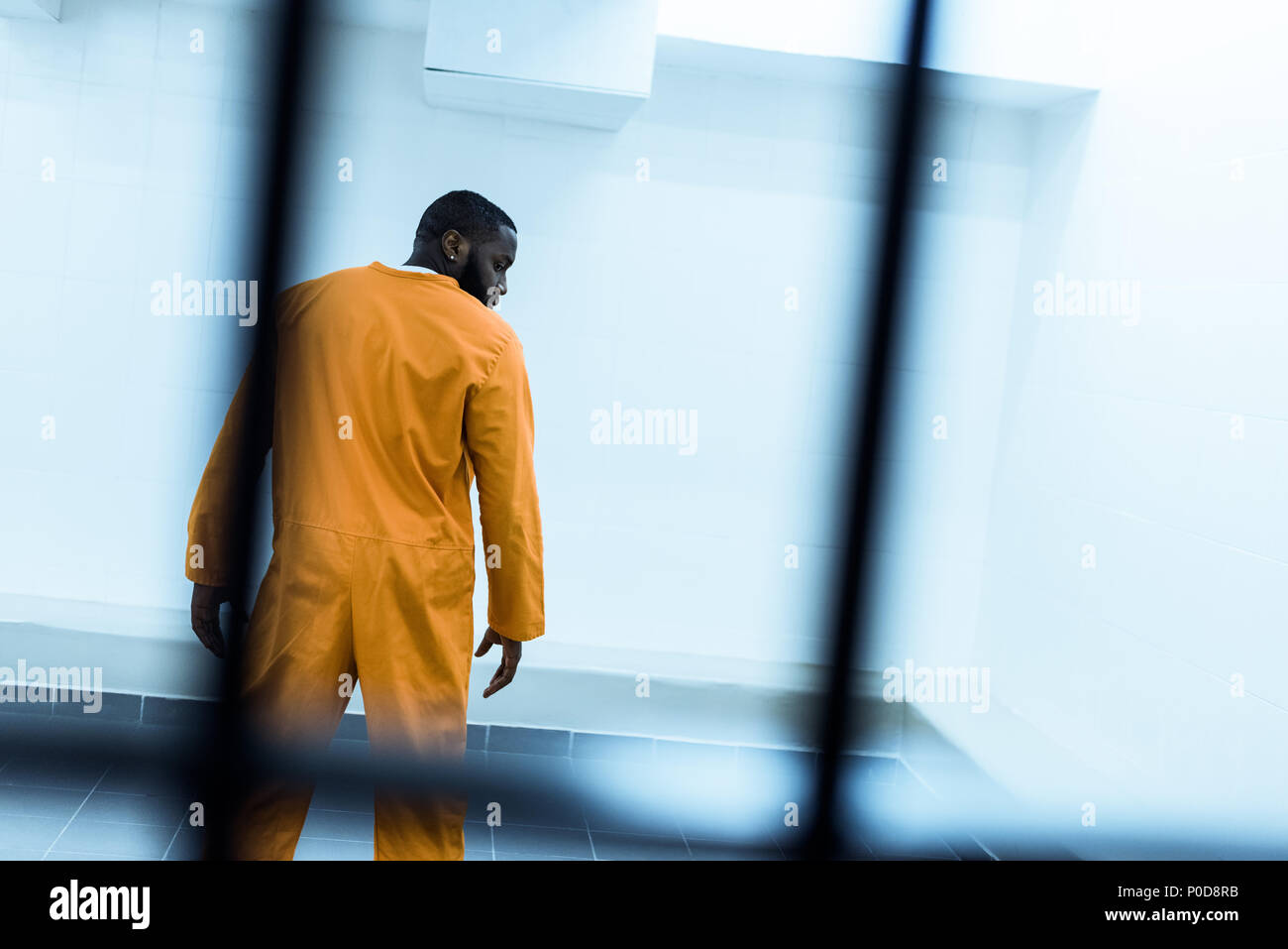 back view of african american prisoner in prison cell Stock Photo - Alamy