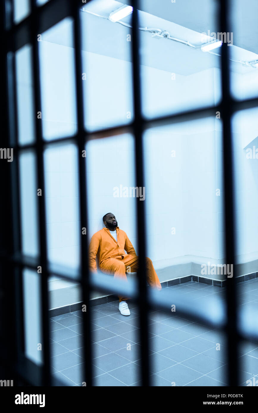 african american prisoner sitting on bench in prison cell Stock Photo ...