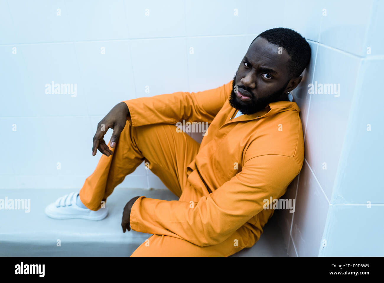african american prisoner sitting on bench and looking at camera Stock ...