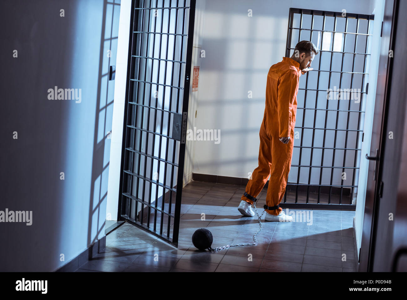 prisoner walking in corridor with weight tethered to leg Stock Photo ...
