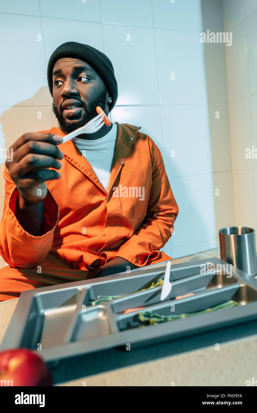 african american criminal eating in prison cell Stock Photo - Alamy