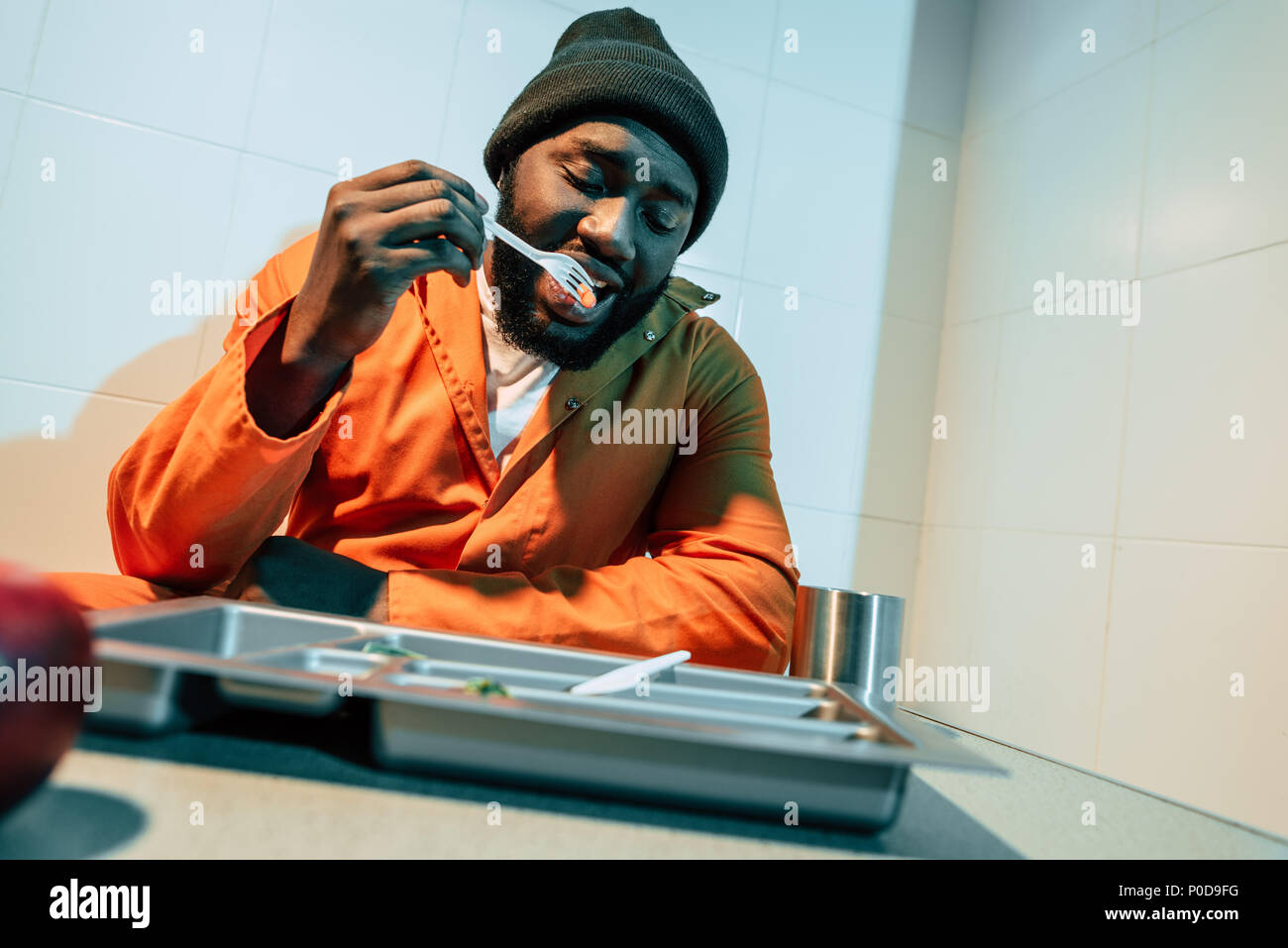 african american convict eating in prison cell Stock Photo - Alamy