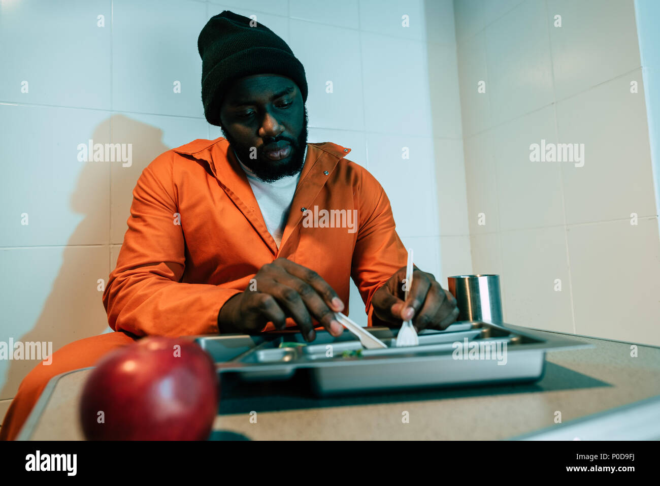 african american inmate eating in prison cell Stock Photo - Alamy