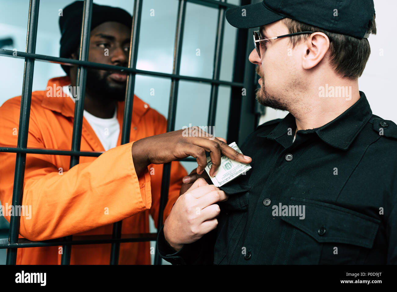 african american prisoner giving money to prison officer as bribe Stock ...