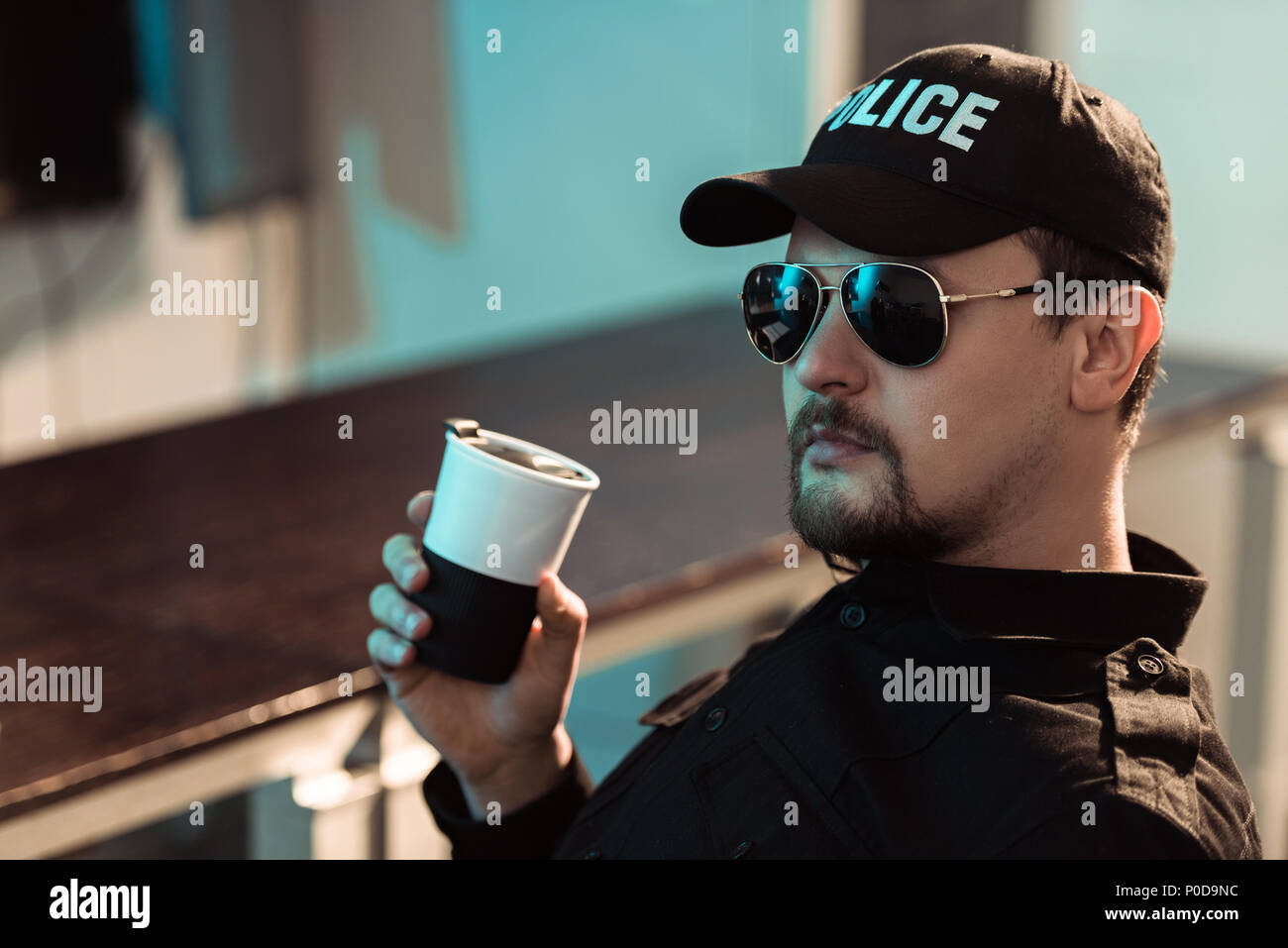 prison guard holding cup of coffee Stock Photo - Alamy