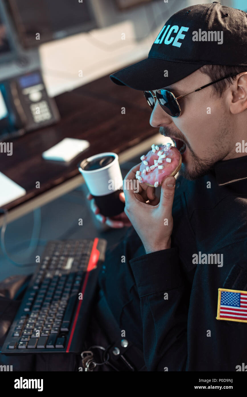 Police eating donut hi-res stock photography and images - Alamy