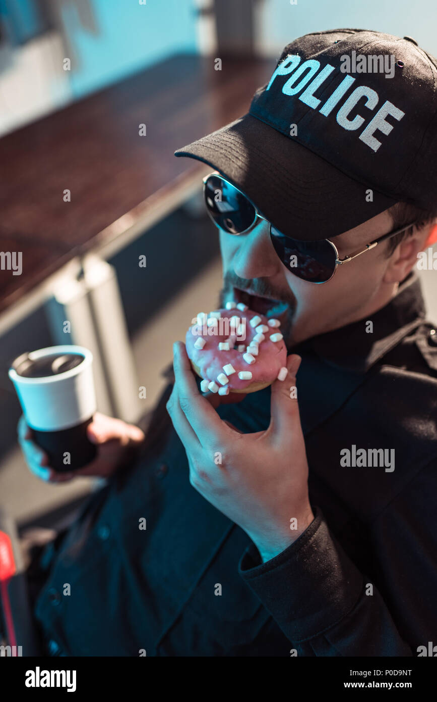 Police eating donut hi-res stock photography and images - Alamy