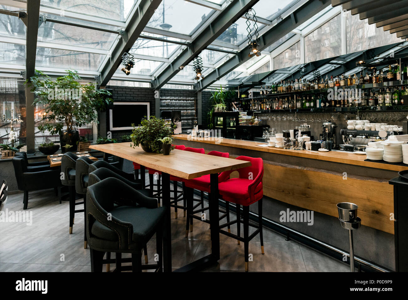 view of stylish empty cafe with arranged tables and chairs for visitors ...