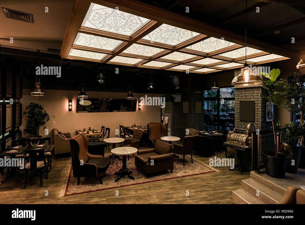 view of stylish empty cafe with arranged tables and chairs for visitors ...