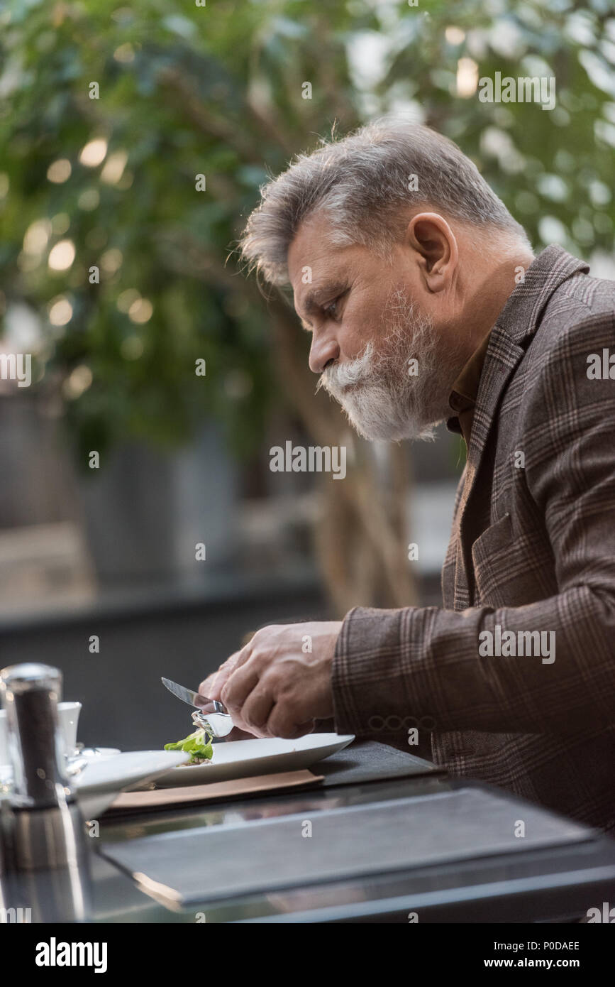 side view of man having dinner in restaurant Stock Photo - Alamy