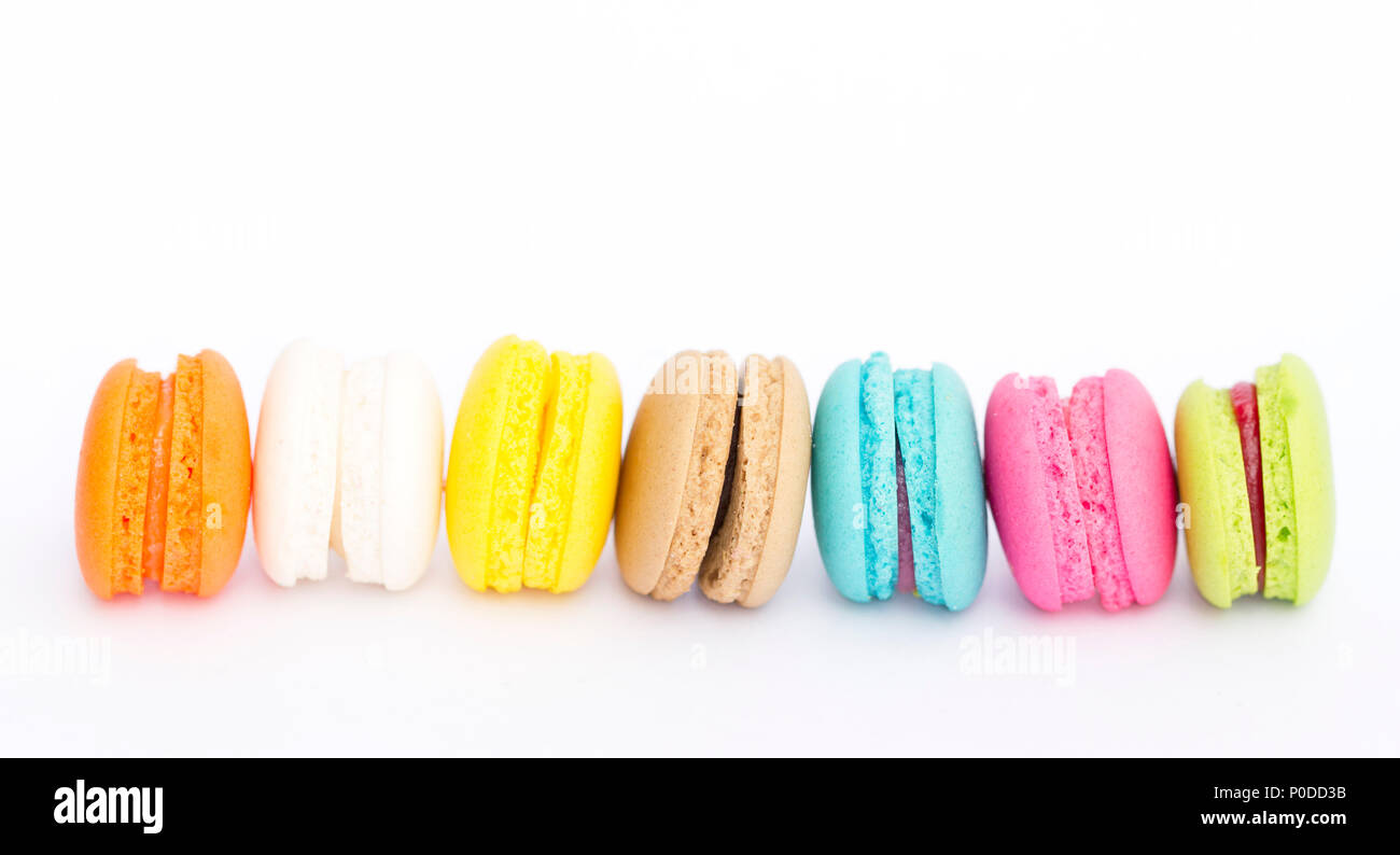 Colorful macarons line isolated on white background Stock Photo - Alamy