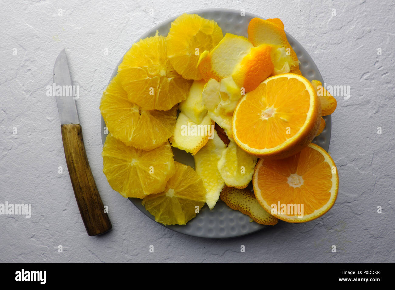 Orange pieces on grey plate closeup Stock Photo - Alamy